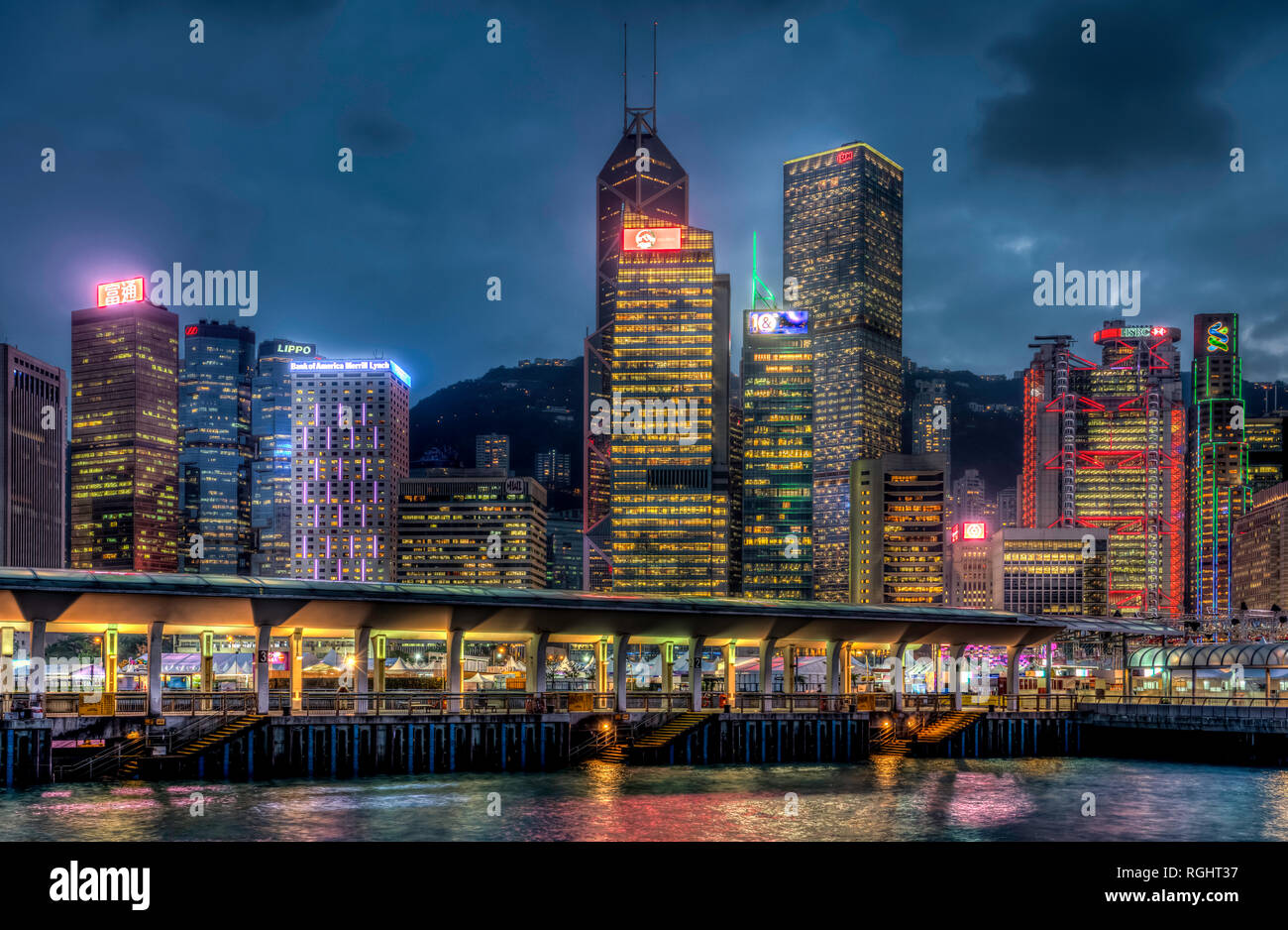 The city skyline of tall buildings illuminated at night on Hong Kong ...