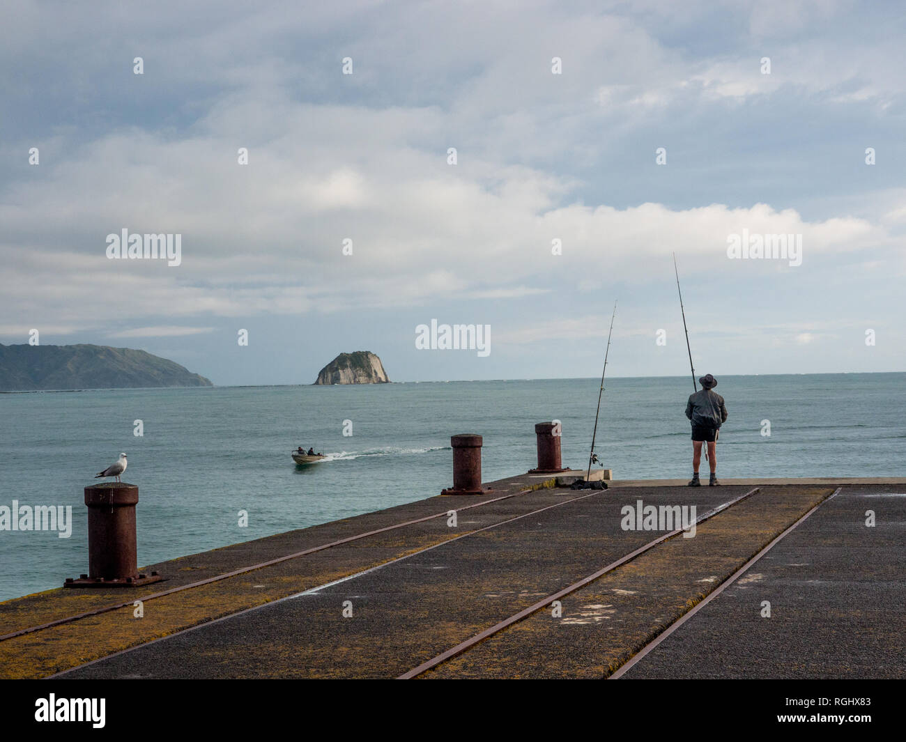 Fisherman, Tologa Bay Wharf, East Cape, North Island, New Zealand Stock ...