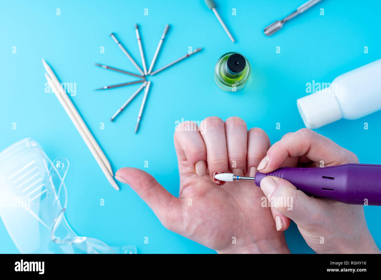 Female manicurist doing a professional manicure hardware using milling ...