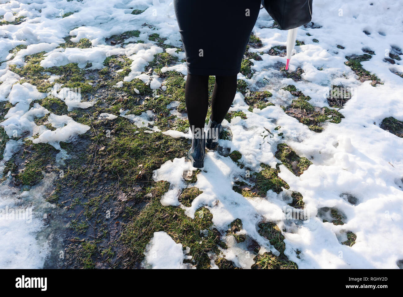 Woman walking thru the slush making steps Stock Photo - Alamy