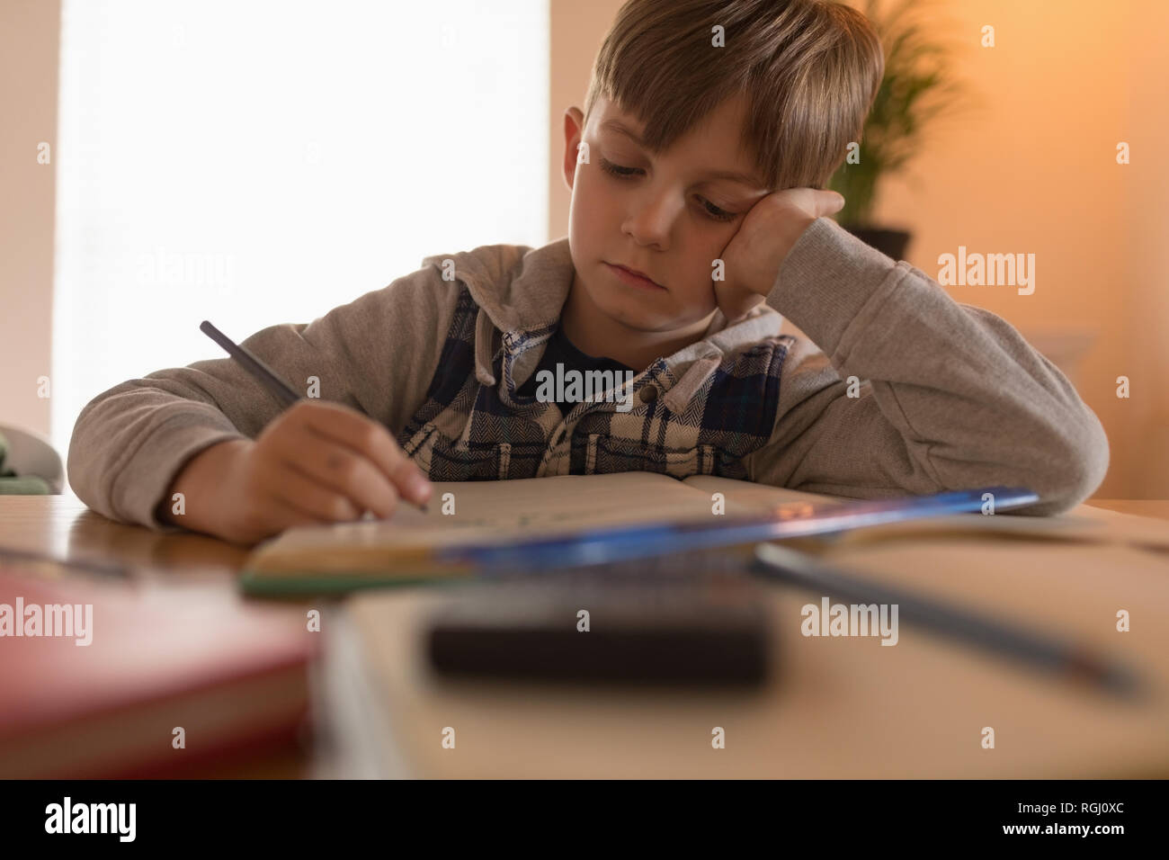 Boy doing his homework at home Stock Photo - Alamy