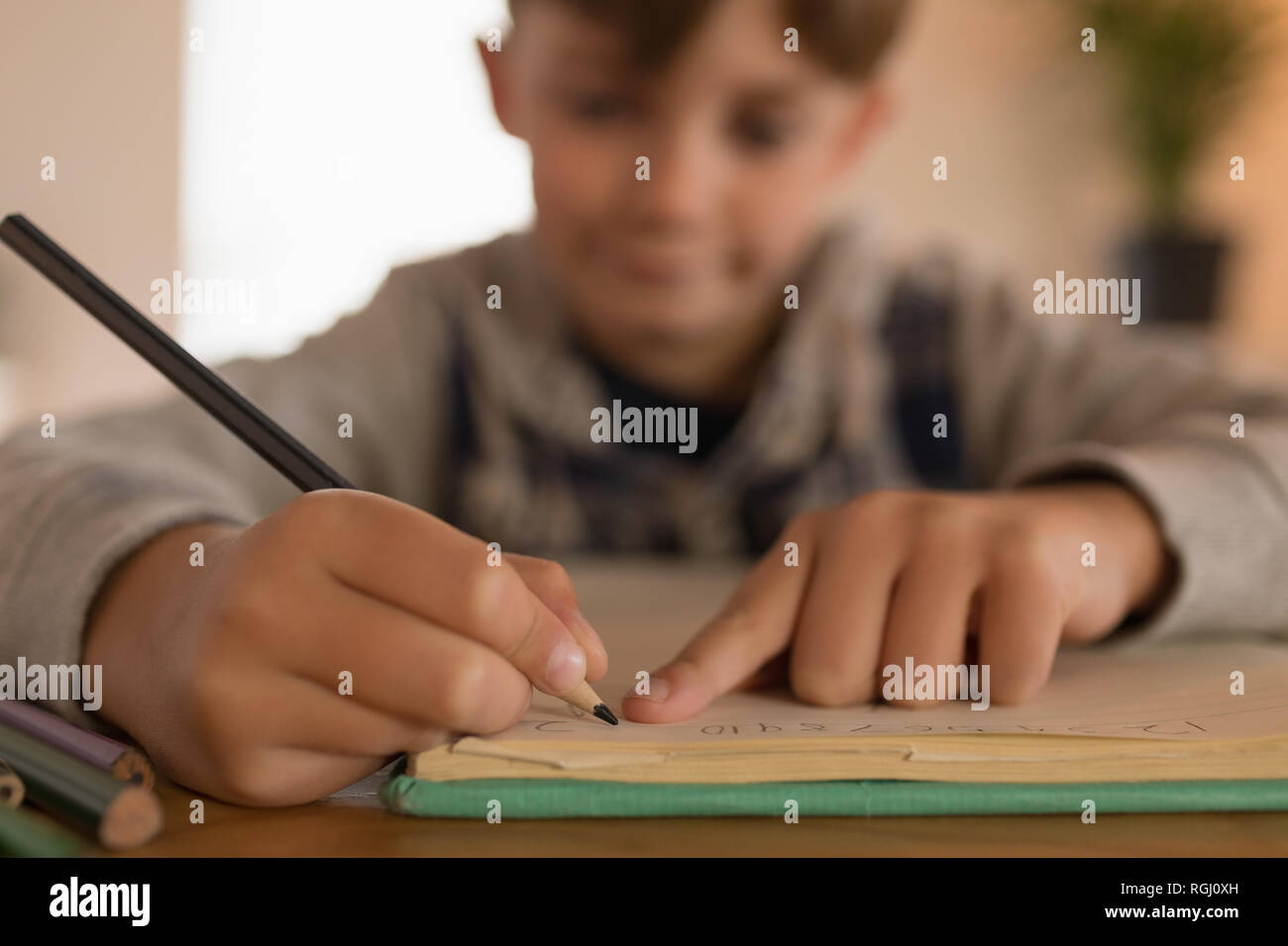 Boy doing his homework at home Stock Photo - Alamy