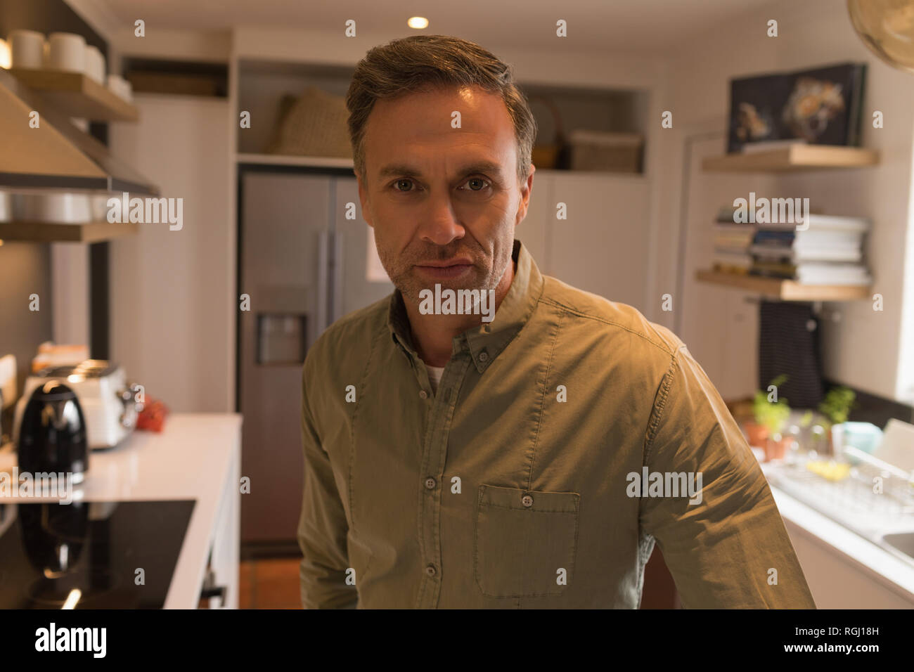 Mature man standing in his modern house hi-res stock photography and ...