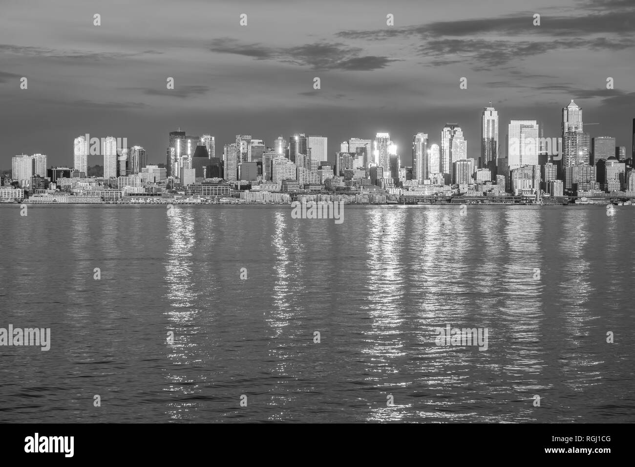 The setting sun is reflected from the skyscrapers in the Seattle ...