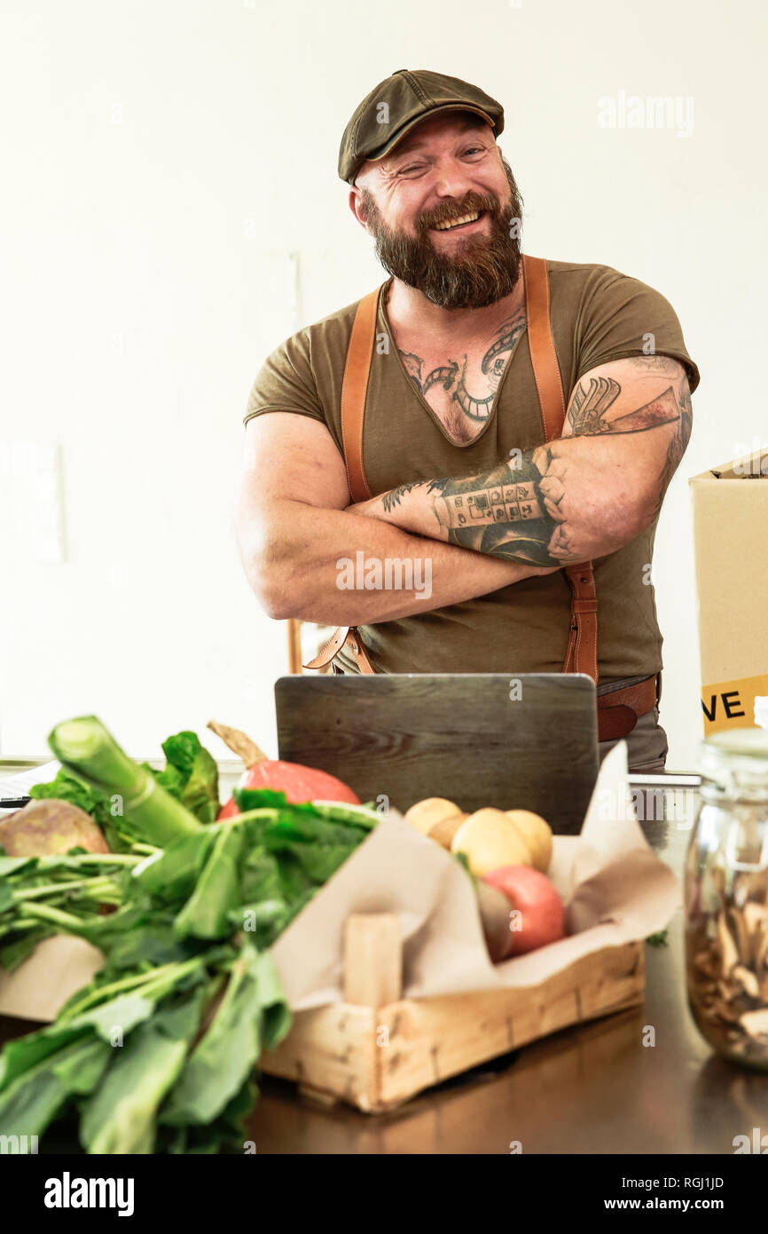 Owner of a delivery service for organic vegetables, standing proud in ...