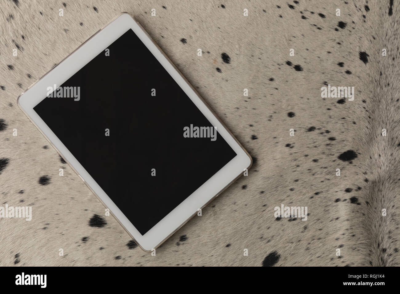 Digital tablet on a carpet at home Stock Photo - Alamy