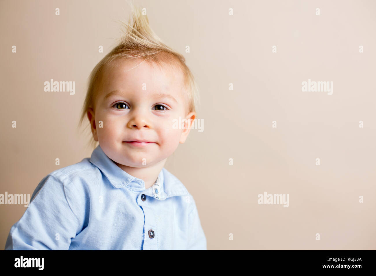 Portrait of cute baby toddler boy, isolated on beige background, child ...