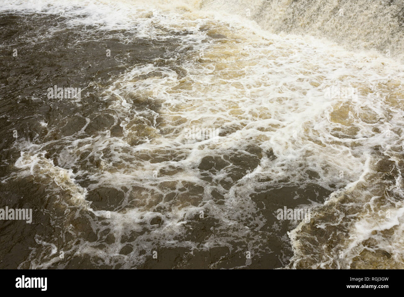 Turbulent water in fast flowing river Irwell at burrs country park in ...