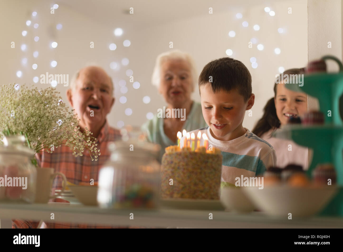 Front view of a multi-generation family celebrating birthday of ...