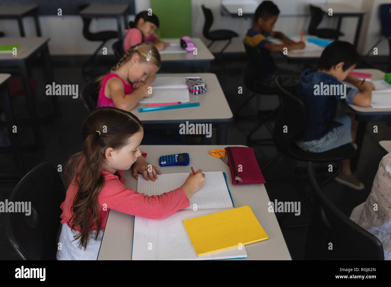 Kids studying in classroom Stock Photo - Alamy