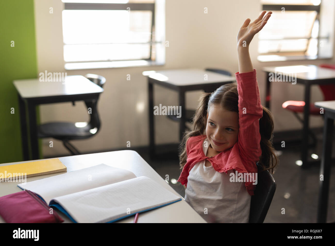 Female student raised hand desk hi-res stock photography and images - Alamy