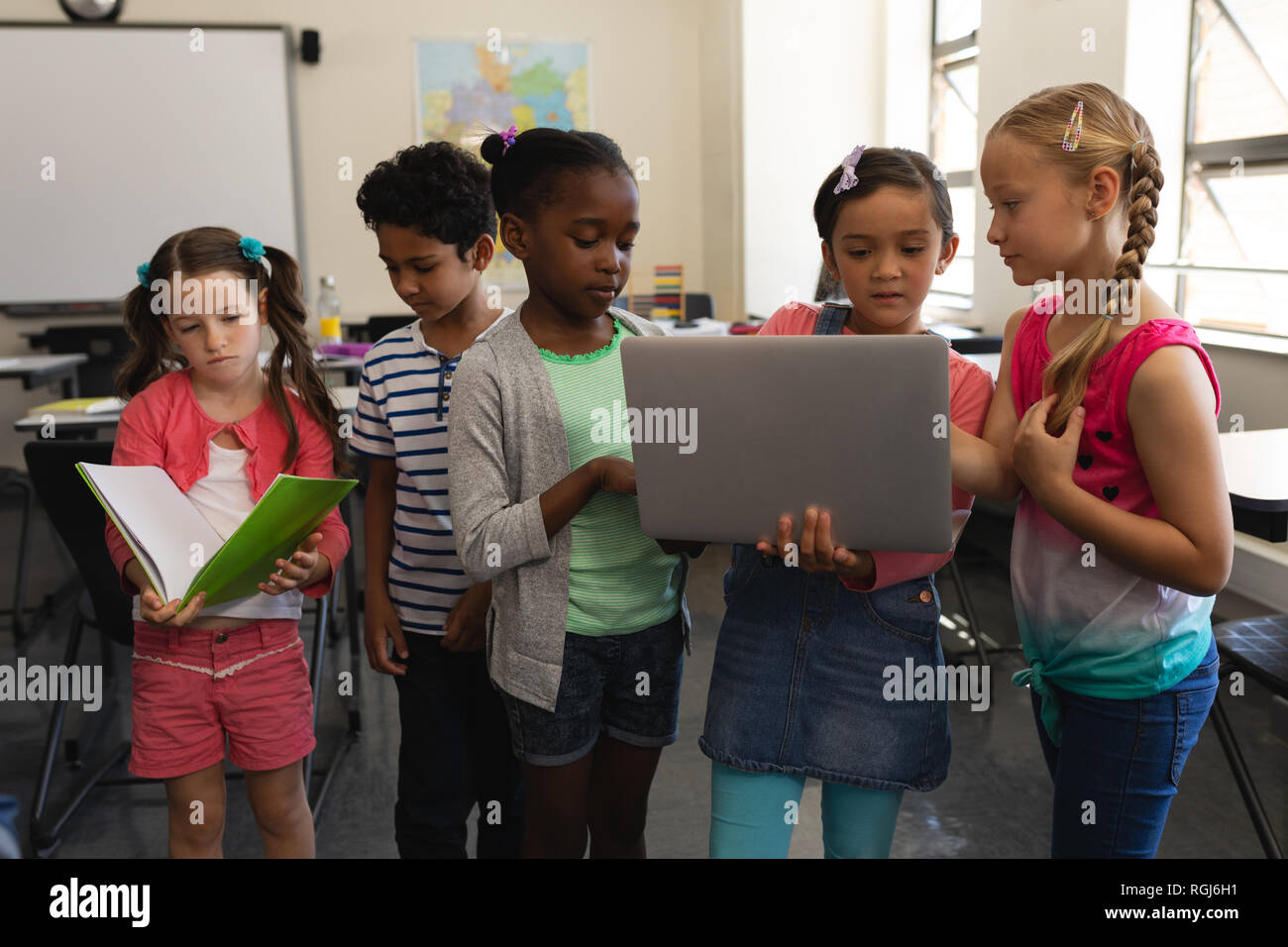 Group of school kids studying together in classroom of elementary ...