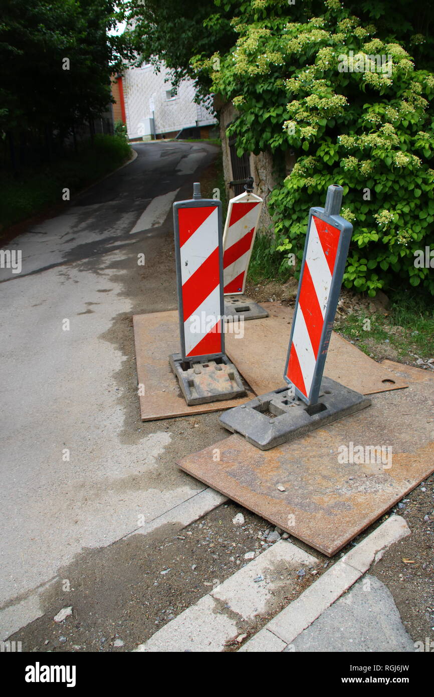 Barricade with a warning sign on a side street Stock Photo - Alamy