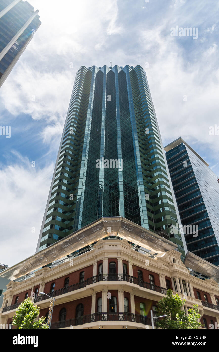 Old Victorian brick building in front of modern highrise skyscraper in ...