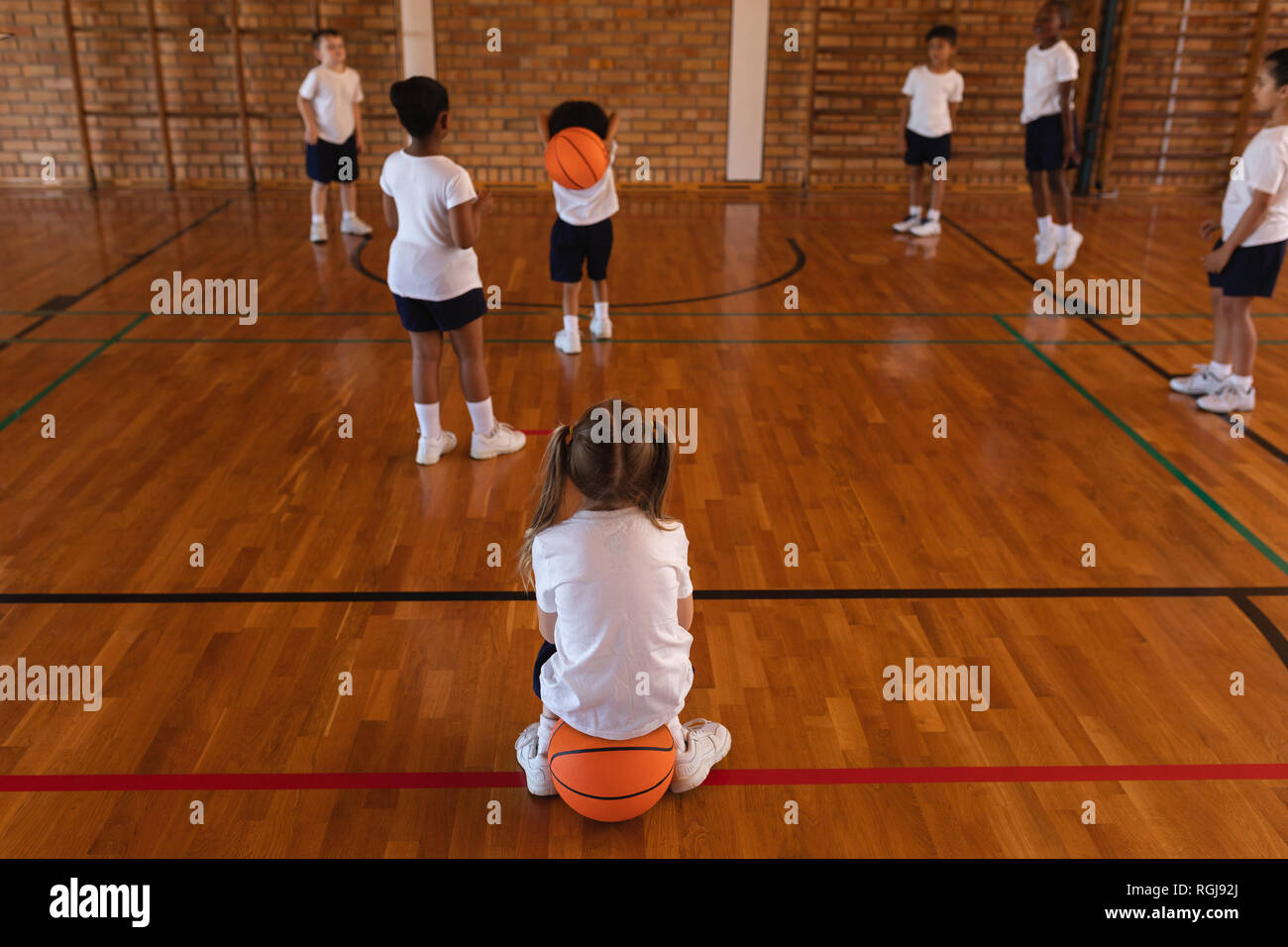 Schoolkids playing basketball at basketball court Stock Photo - Alamy