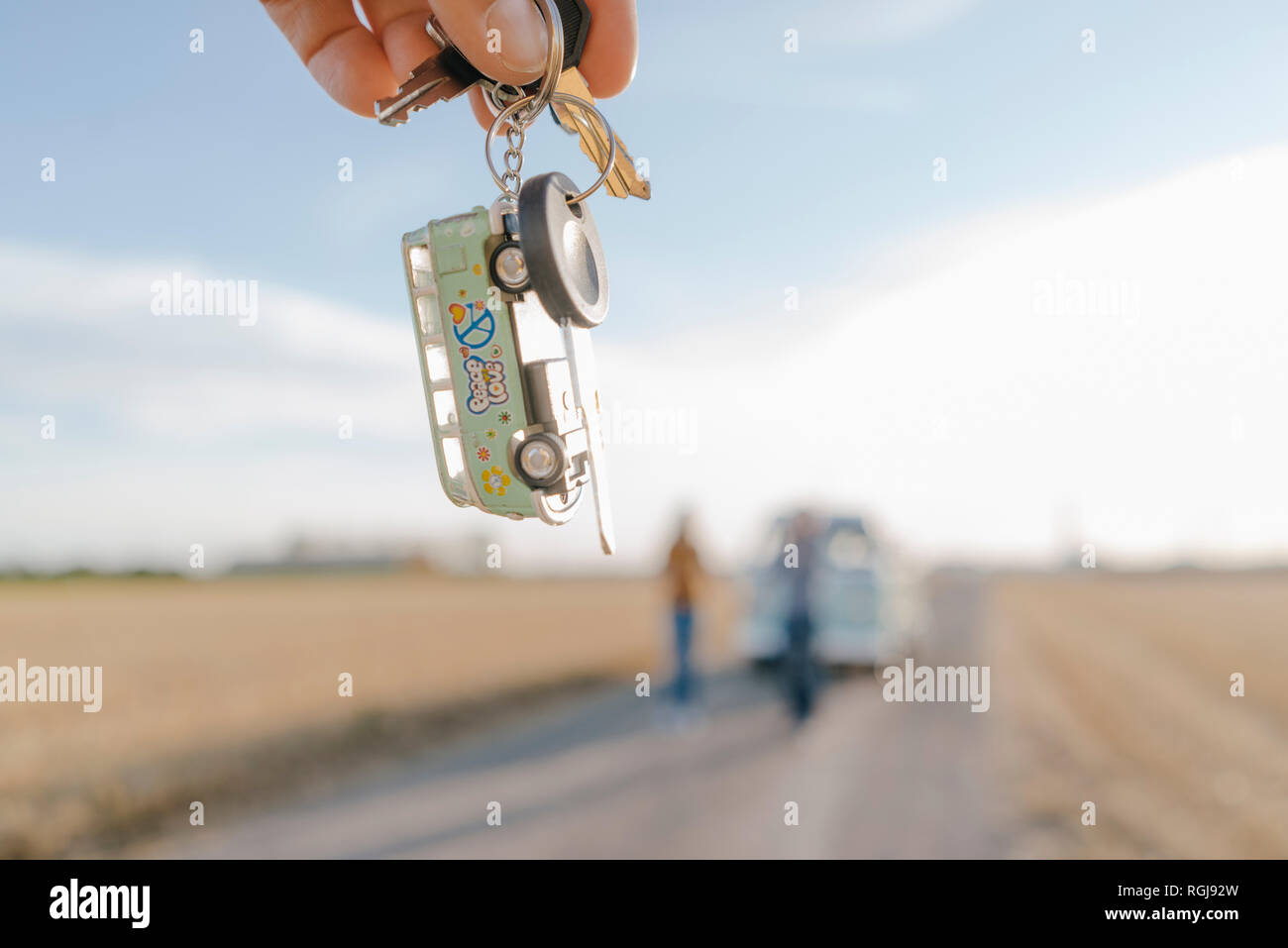 Hand holding camper van key in rural landscape Stock Photo - Alamy