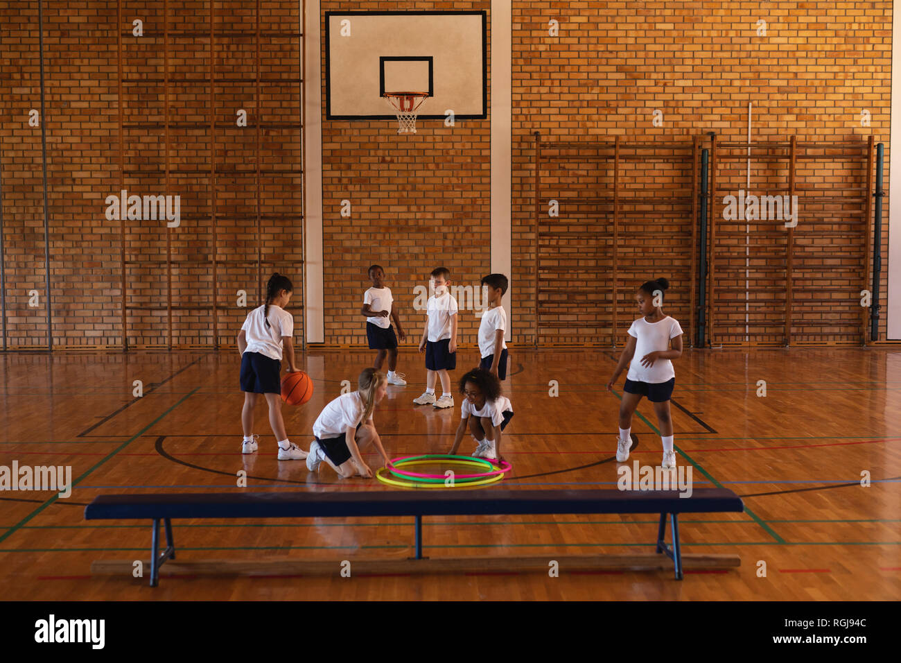 Schoolkids playing basketball at basketball court Stock Photo - Alamy