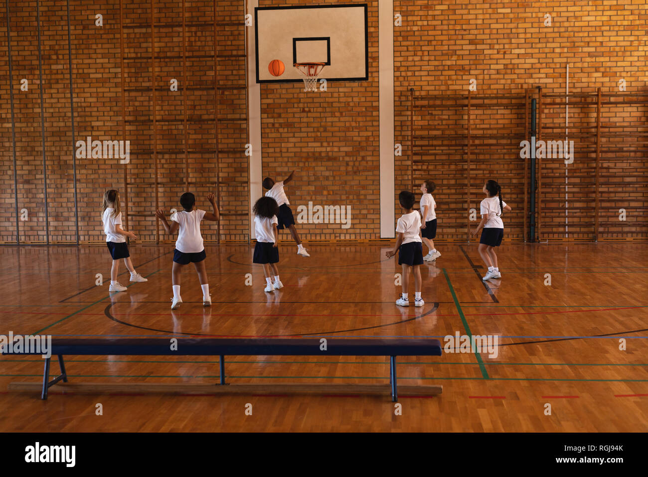 Schoolkids playing basketball at basketball court Stock Photo - Alamy