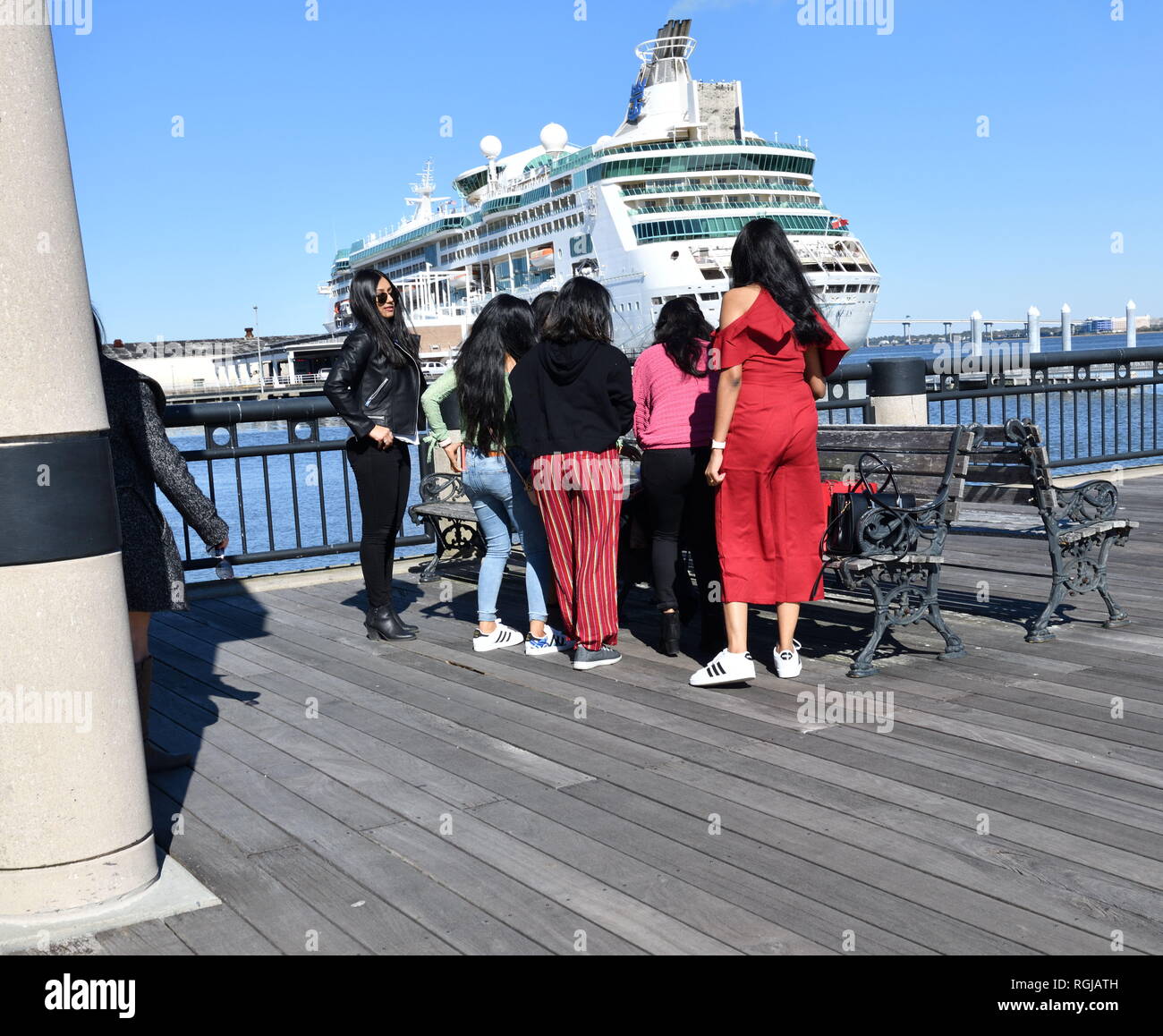Waterfront Dock with Cruise Ship in Distance and Visitors Clustered ...