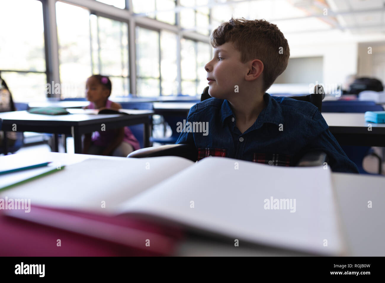 Boy alone in classroom hi-res stock photography and images - Alamy