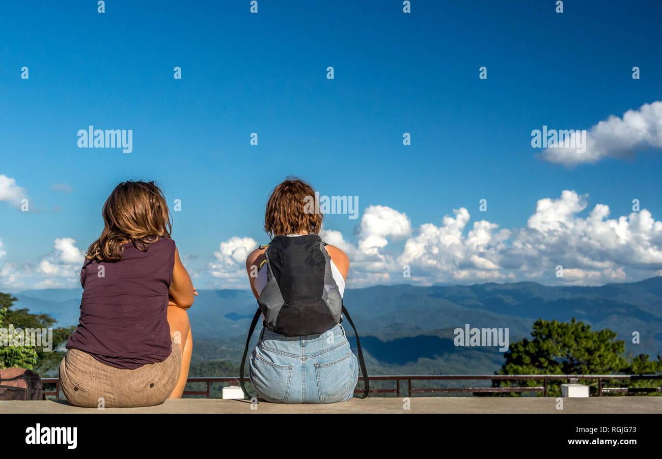 Two young women sit chatting whilst enjoying the stunning Northern ...