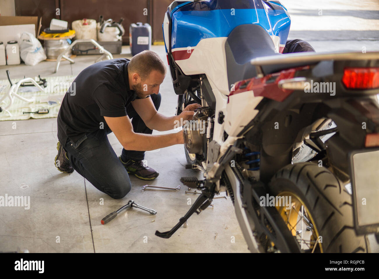 Repairman working on motorbike hi-res stock photography and images - Alamy