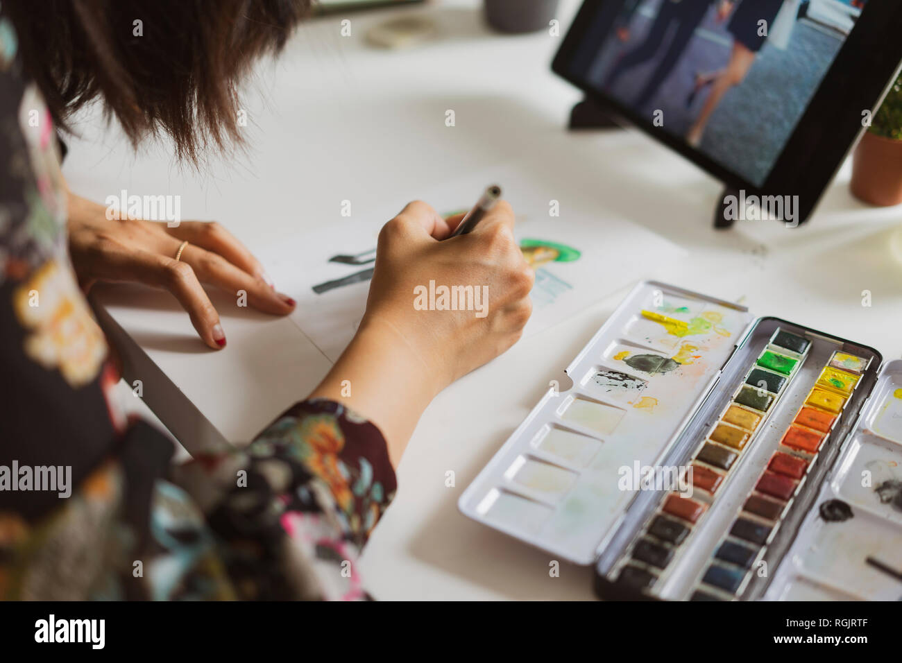 Illustrator painting at work desk, close-up Stock Photo - Alamy