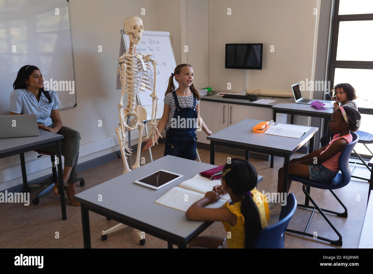 Side view schoolkids studying in classroom of elementary school Stock ...