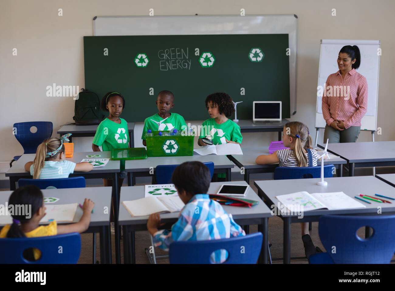 Front view of schoolkids studying about green energy and recycle at ...