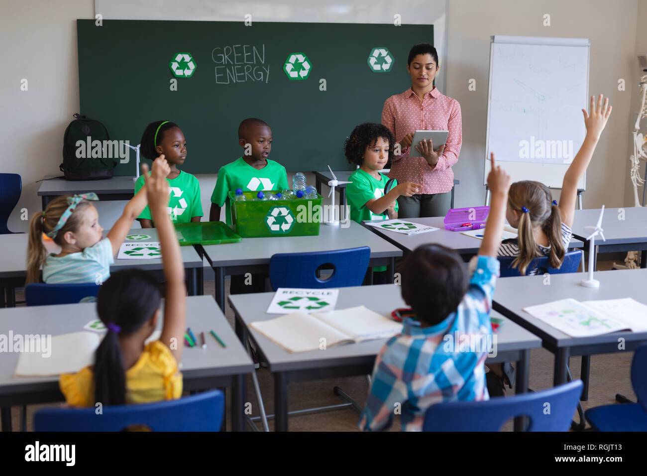 Front view of schoolkids studying about green energy and recycle at ...