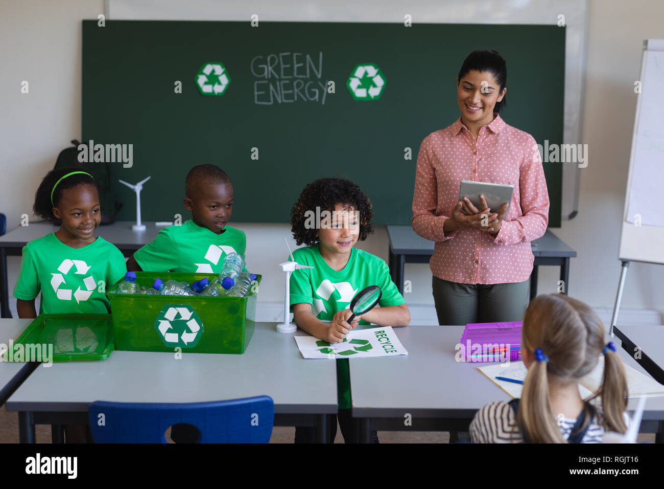 Front view of schoolkids studying about green energy and recycle at ...