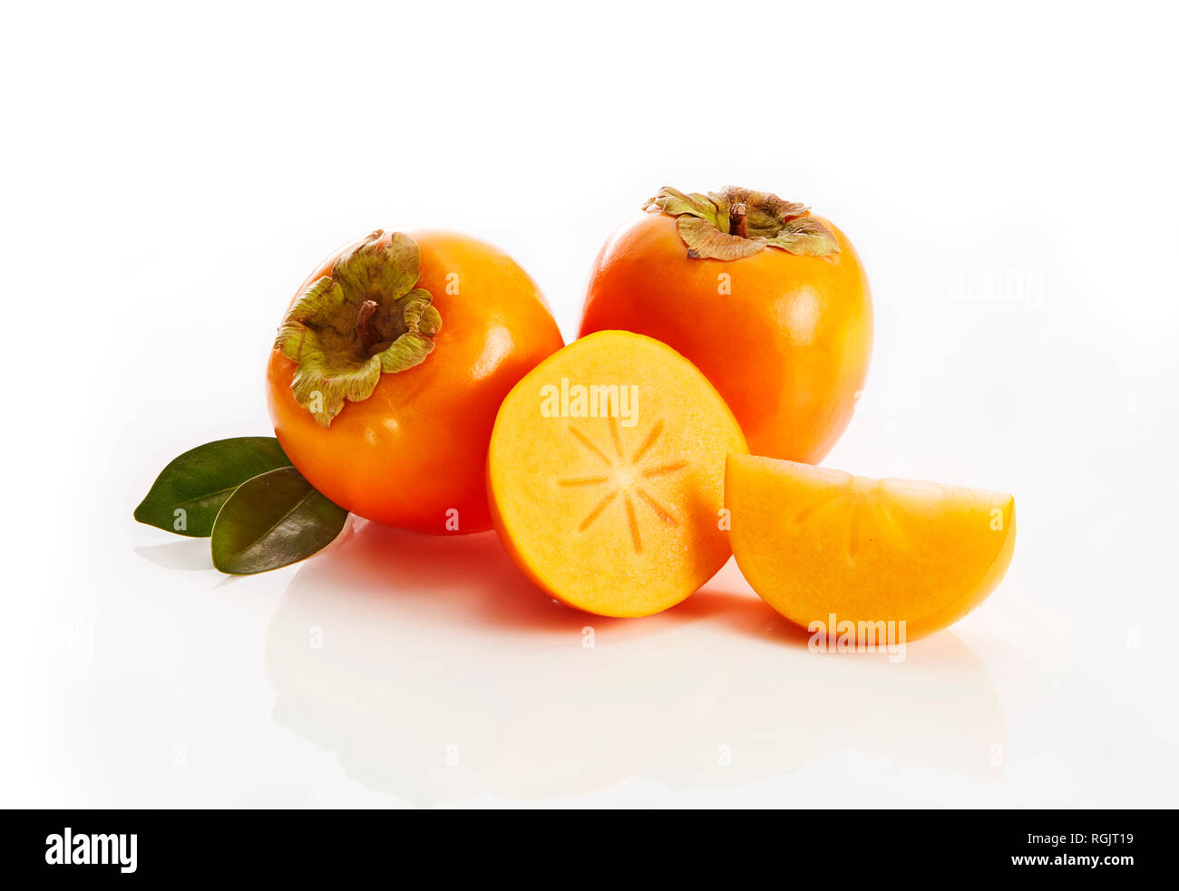 Whole and sliced Kaki on white background Stock Photo - Alamy