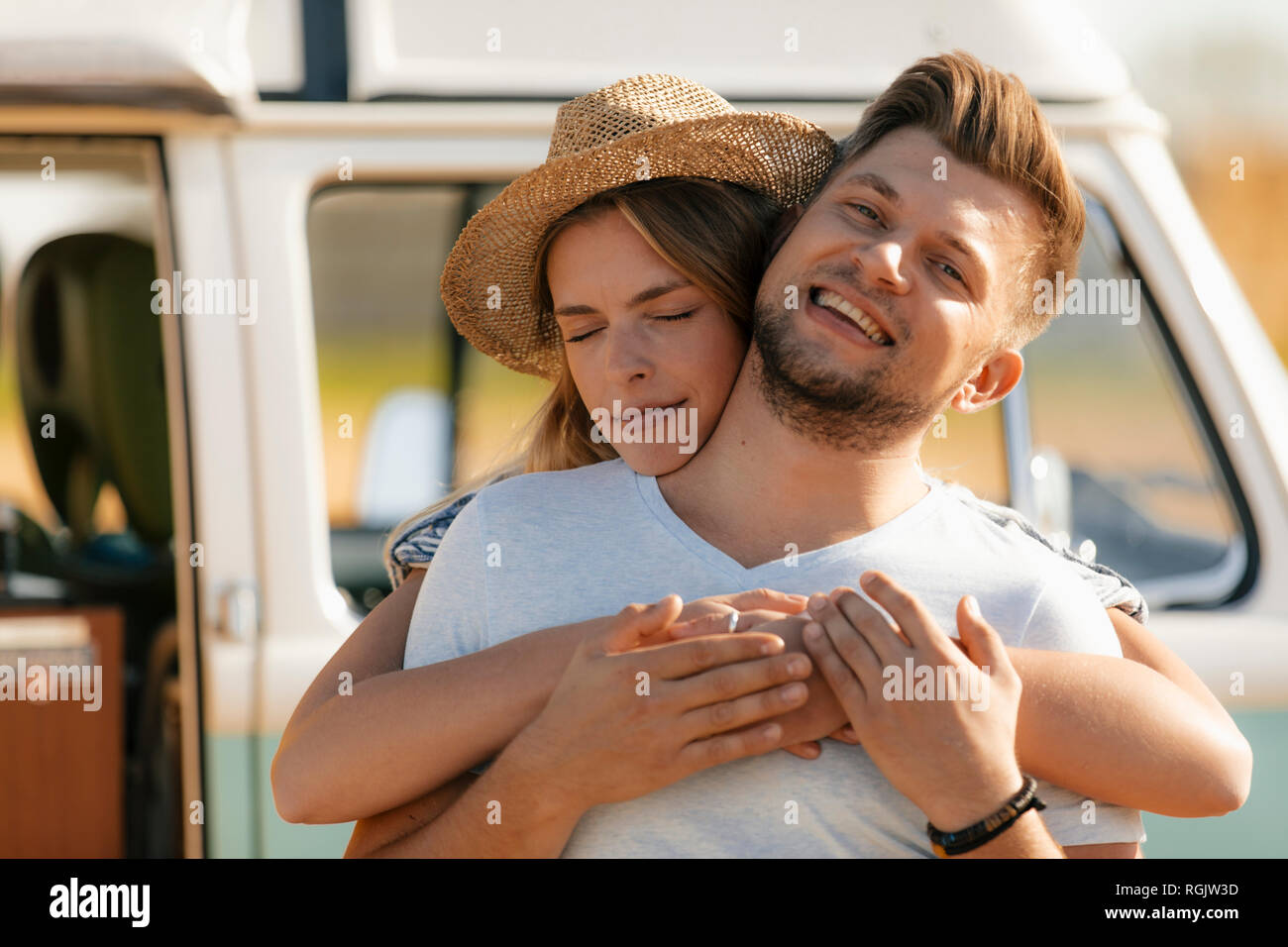 Happy affectionate young couple at camper van Stock Photo - Alamy