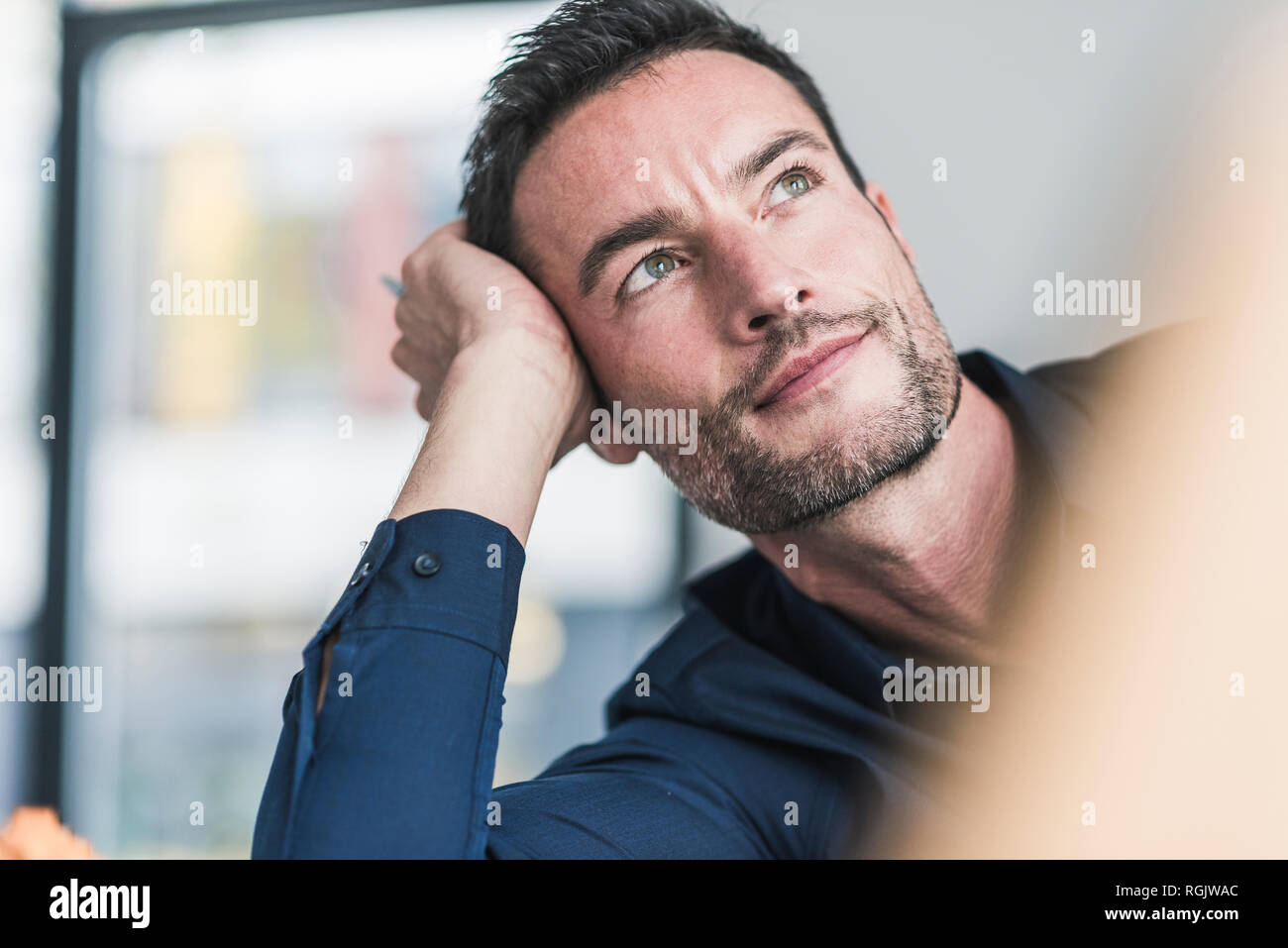 Mature man sitting in office, thinking, leaning head on hand Stock ...