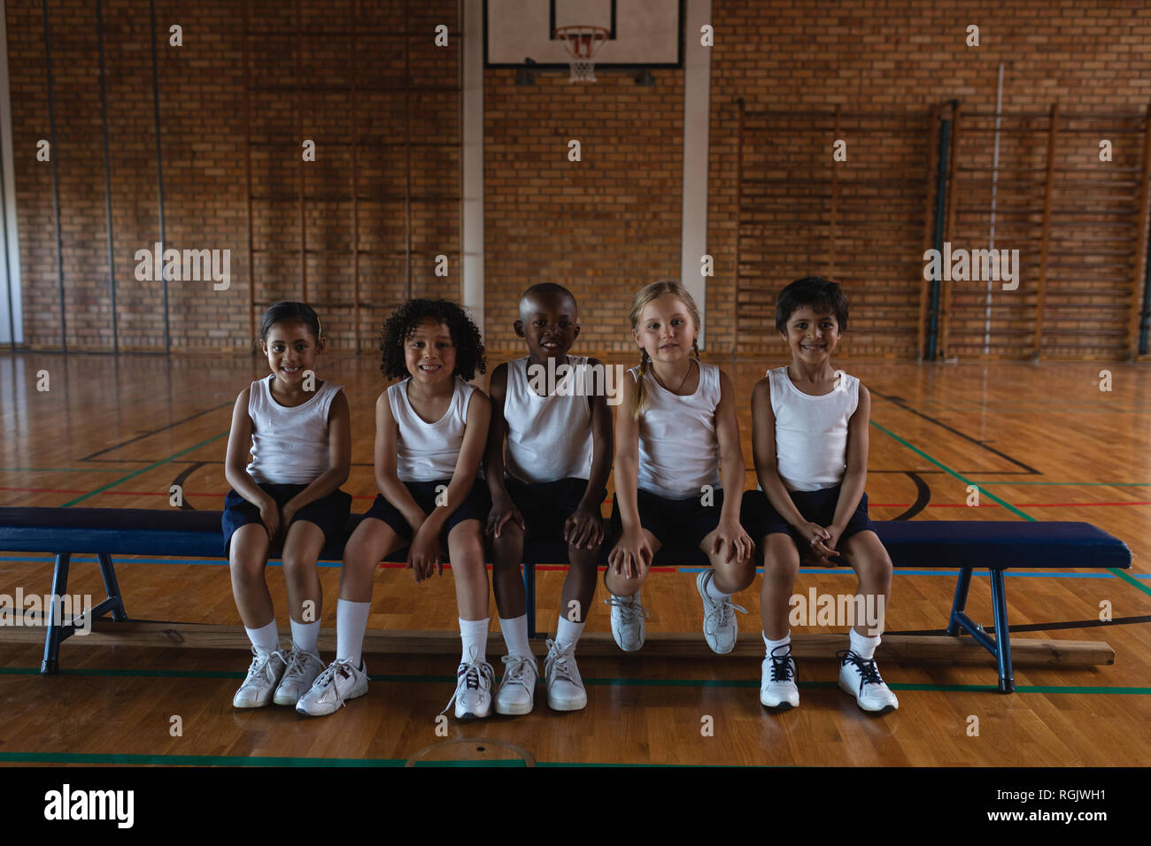 Girl sitting on basketball hi-res stock photography and images - Alamy