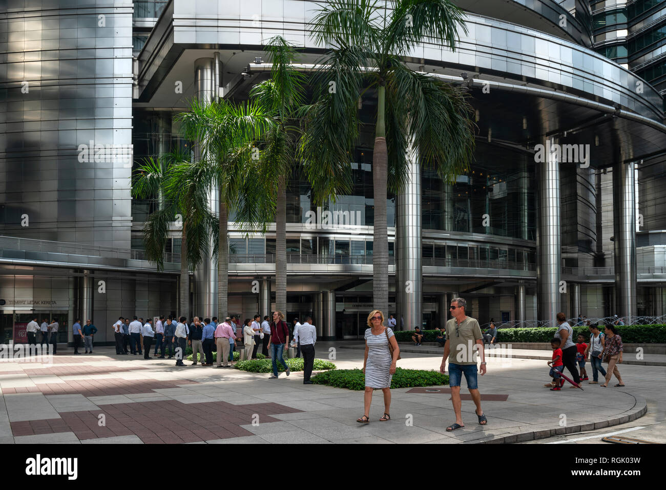 People in front of the entrance of Petronas towers in Kuala Lumpur ...