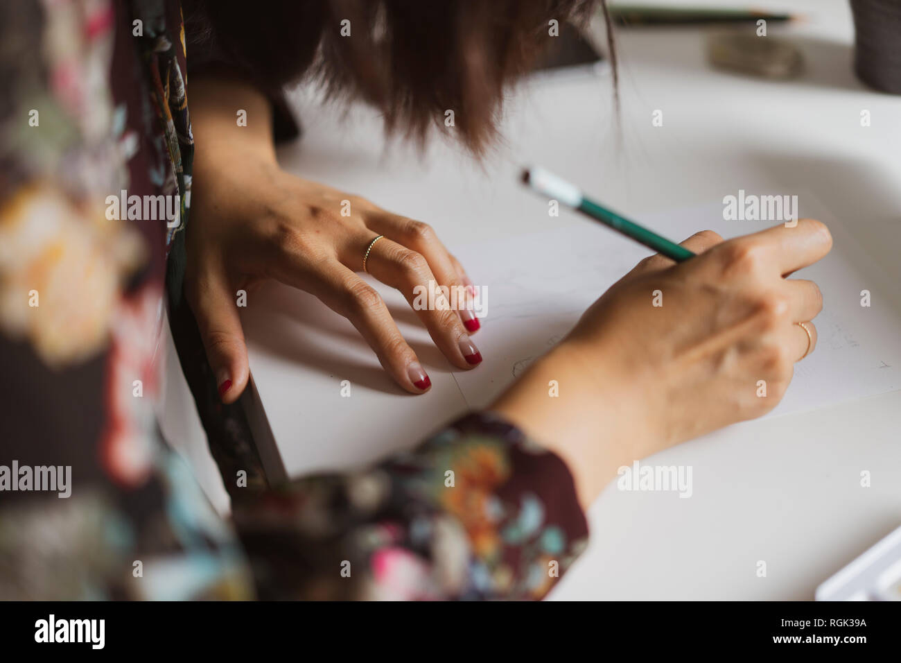 Illustrator drawing at work desk, close-up Stock Photo - Alamy