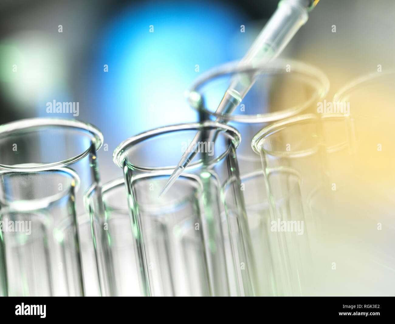 Scientist pipetting a sample into a test tube during a experiment in ...