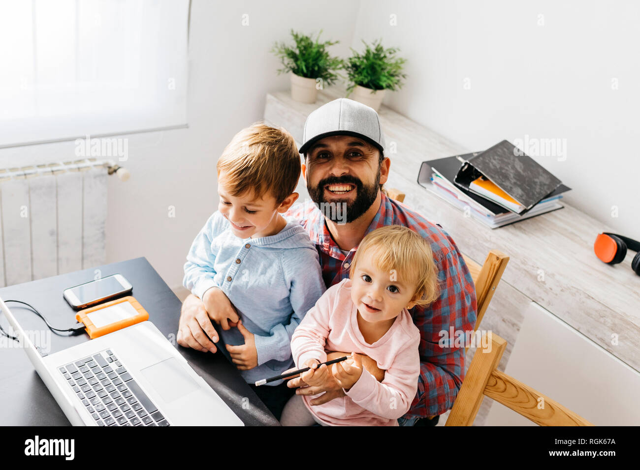 Father at computer with baby on his lap hi-res stock photography and ...