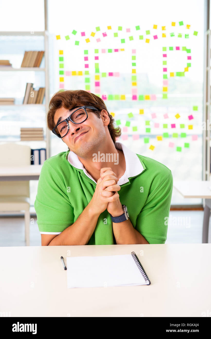 Student struggling at the exam in classroom Stock Photo - Alamy