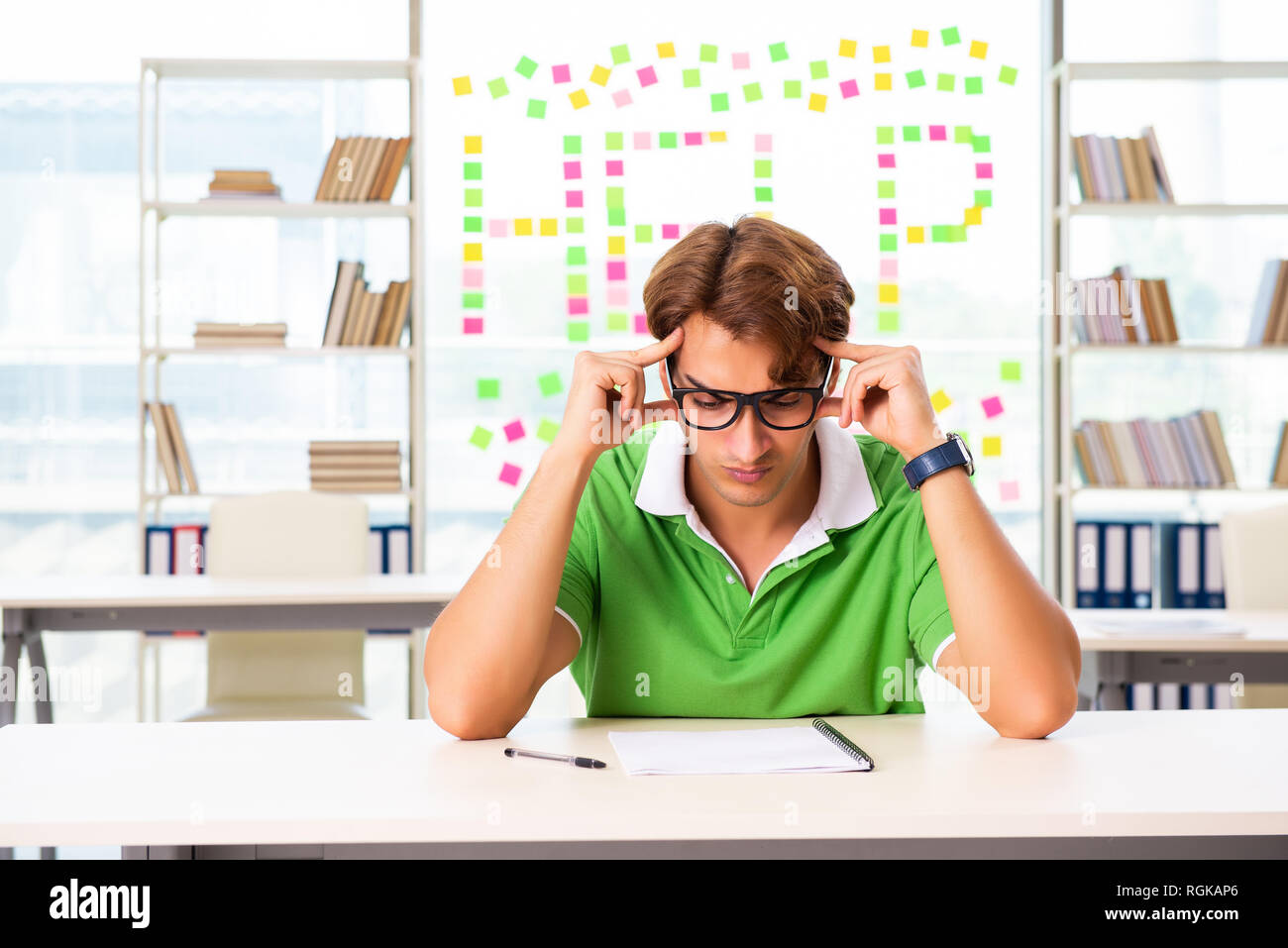 Student struggling at the exam in classroom Stock Photo - Alamy