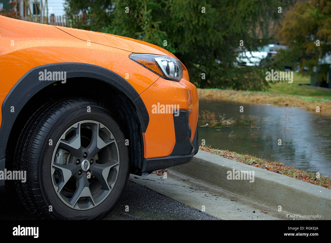 Front wheel of parked orange car Stock Photo - Alamy