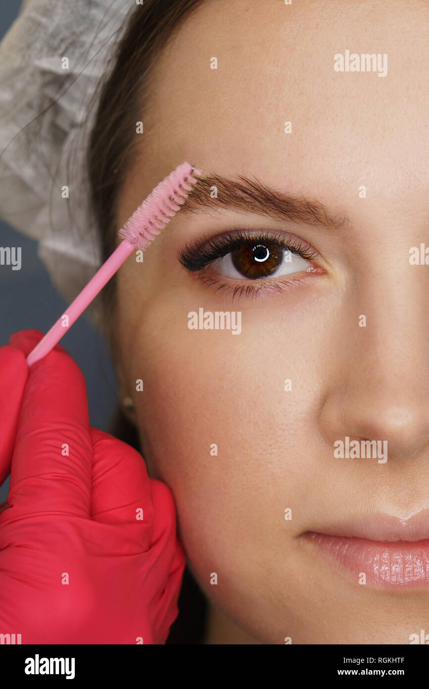 Eyebrow correction. Combing eyebrows and giving direction of hair ...