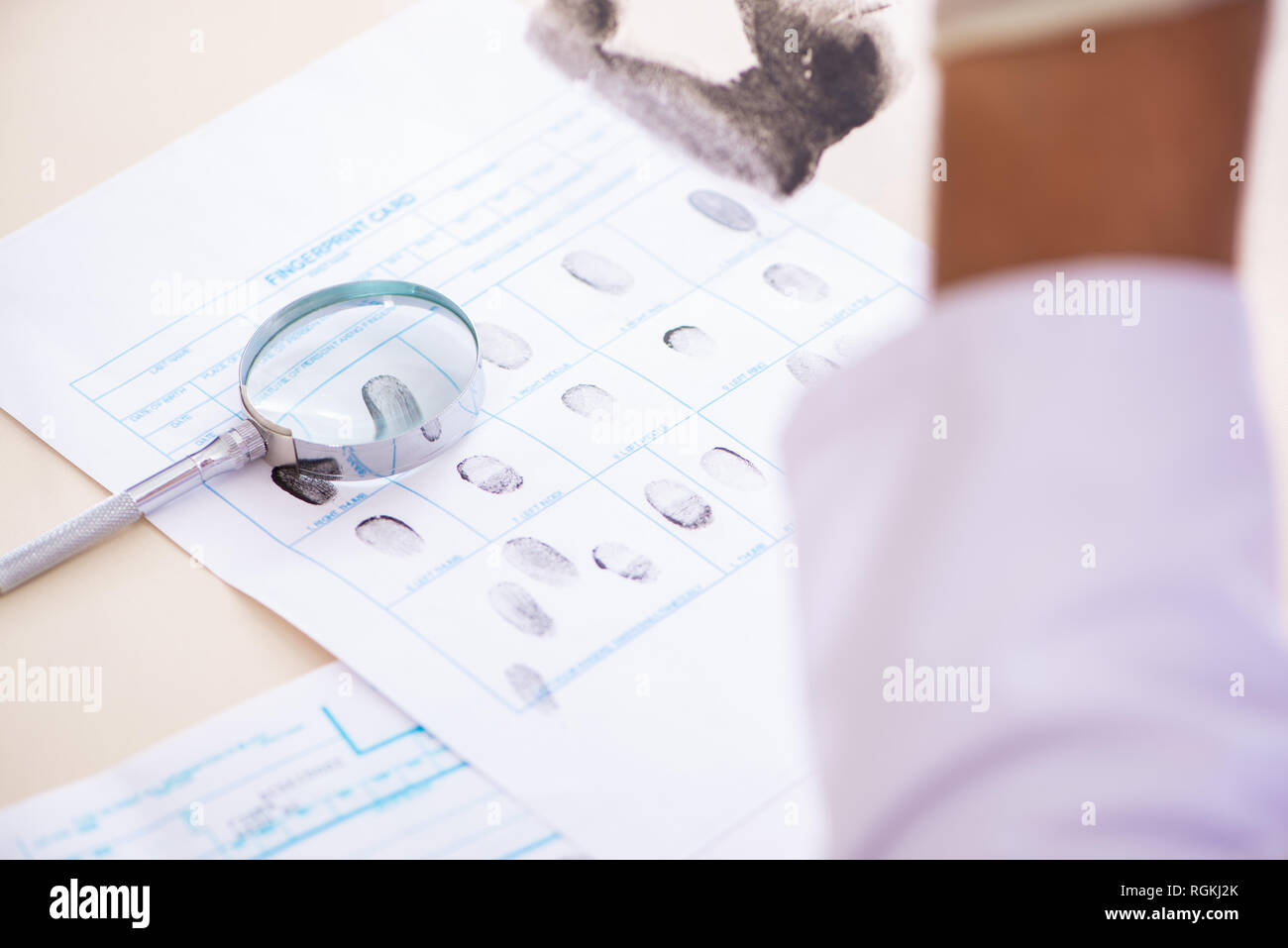 Forensic expert studying fingerprints in the lab Stock Photo - Alamy