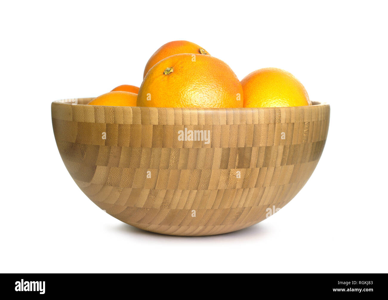 Many ripe appetizing oranges inside big brown wooden bowl isolated on ...