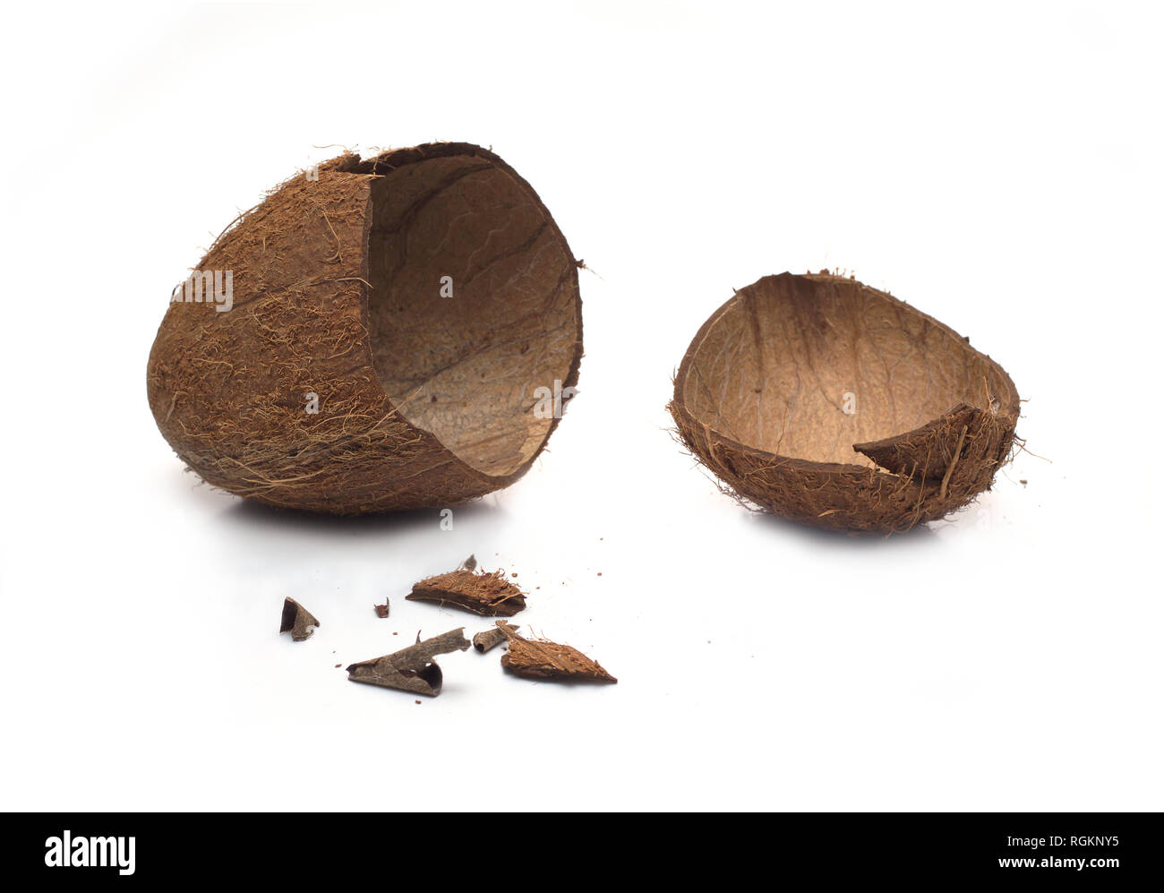 Still life with empty broken coconut shell and smithers isolated on ...
