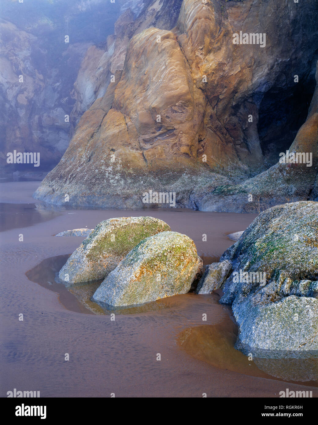 USA, Oregon, Hug Point State Park, Colorful eroded sandstone formation ...