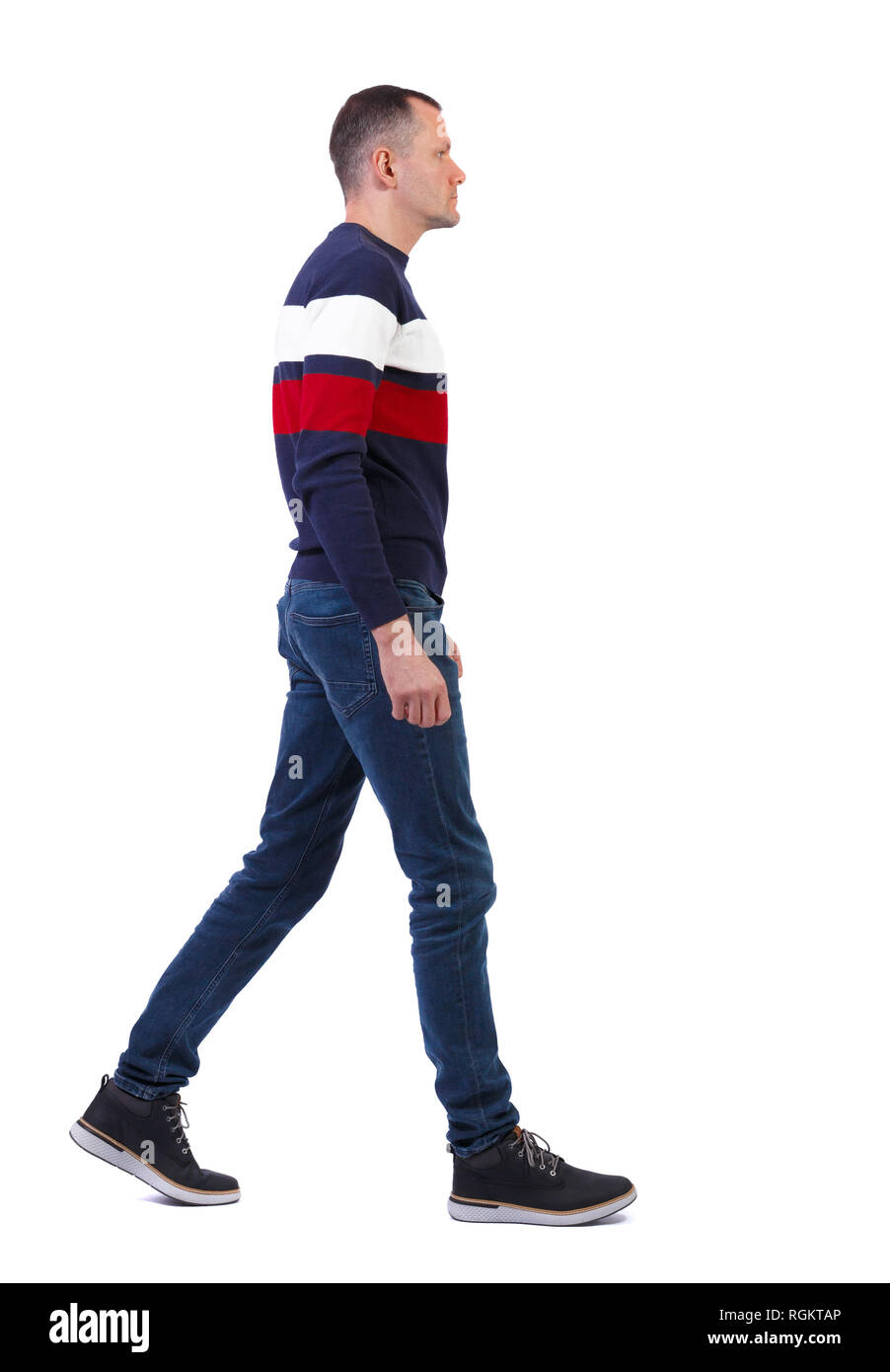 Side view of going handsome man in pullover. walking young guy . Rear ...