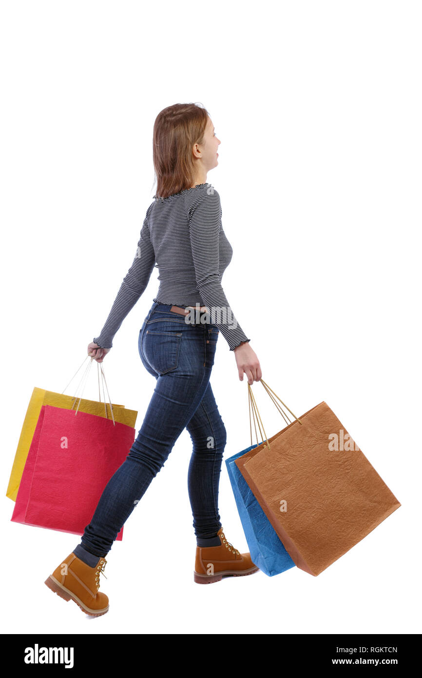 back view of woman with shopping bags . beautiful brunette girl in ...