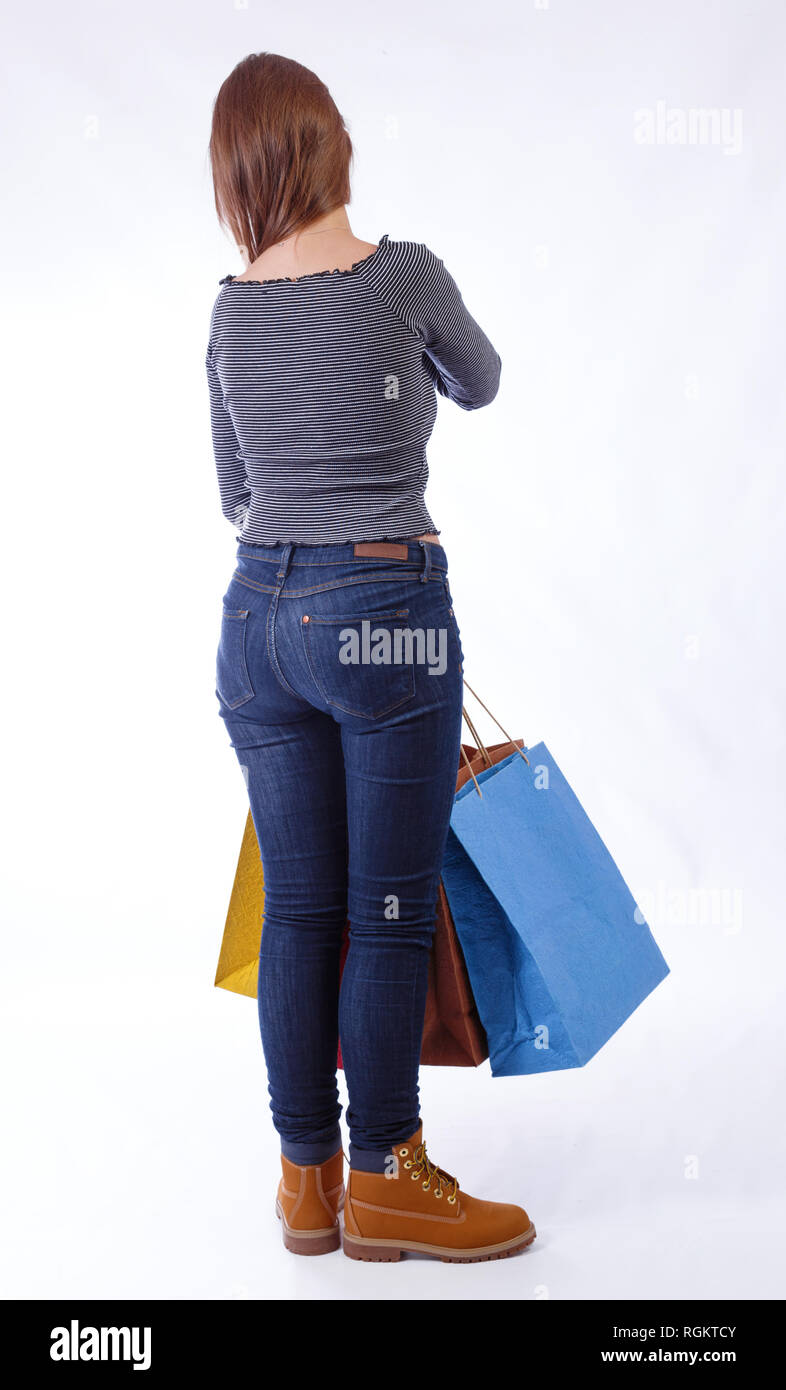 back view of woman with shopping bags . beautiful brunette girl in ...